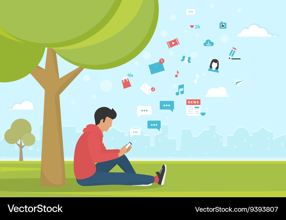 Young man sitting in the park and texting messages