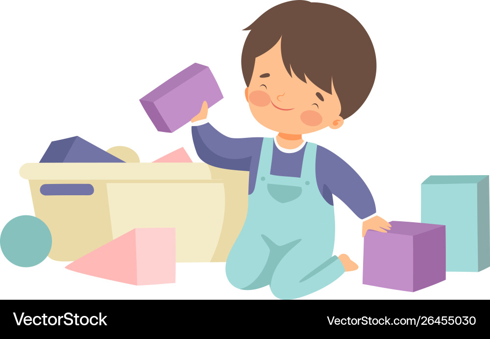 Cute boy sitting on floor and cleaning up his toys