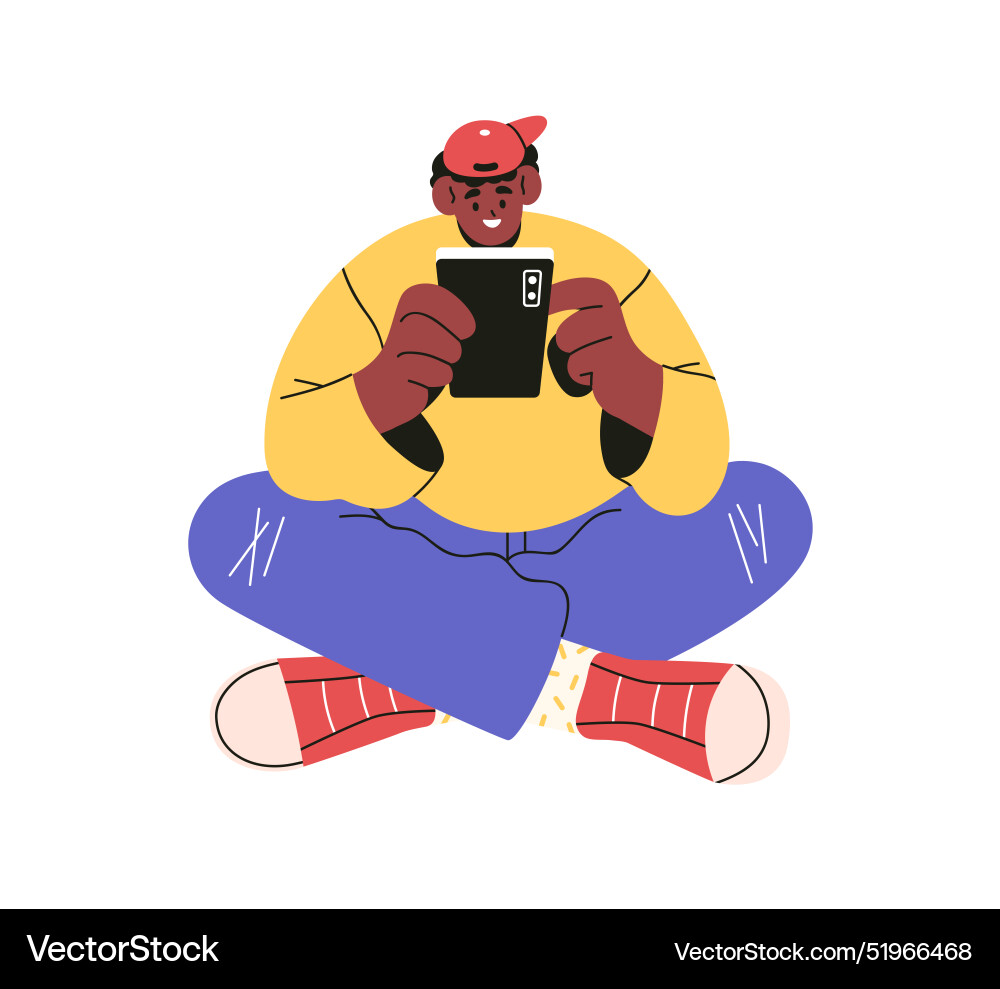 Young black man sitting with mobile phone in hands