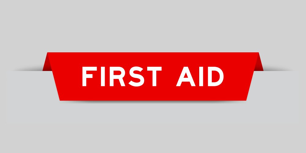 Red color speech banner with word first aid Vector Image