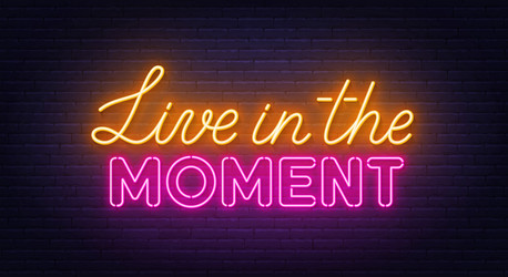 Live in the moment neon lettering on brick wall Vector Image