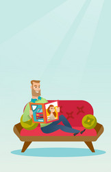 Man reading a magazine on the couch Royalty Free Vector