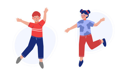 Smiling teen boy and girl jumping with joy raising