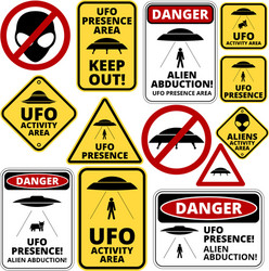 Warning ufo road sign yellow red badge with aliens