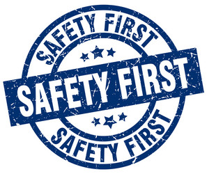 Safety first blue round grunge stamp Royalty Free Vector