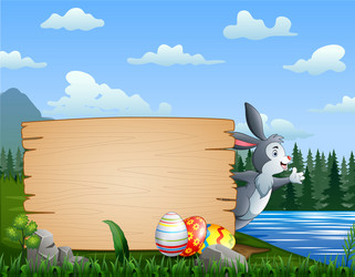 Easter bunny waving hand with blank sign Vector Image