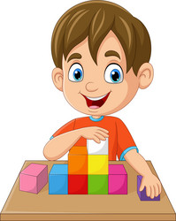 Cartoon boy playing with building blocks Vector Image