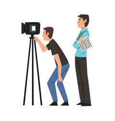 Cameraman shooting film scene with his camera Vector Image